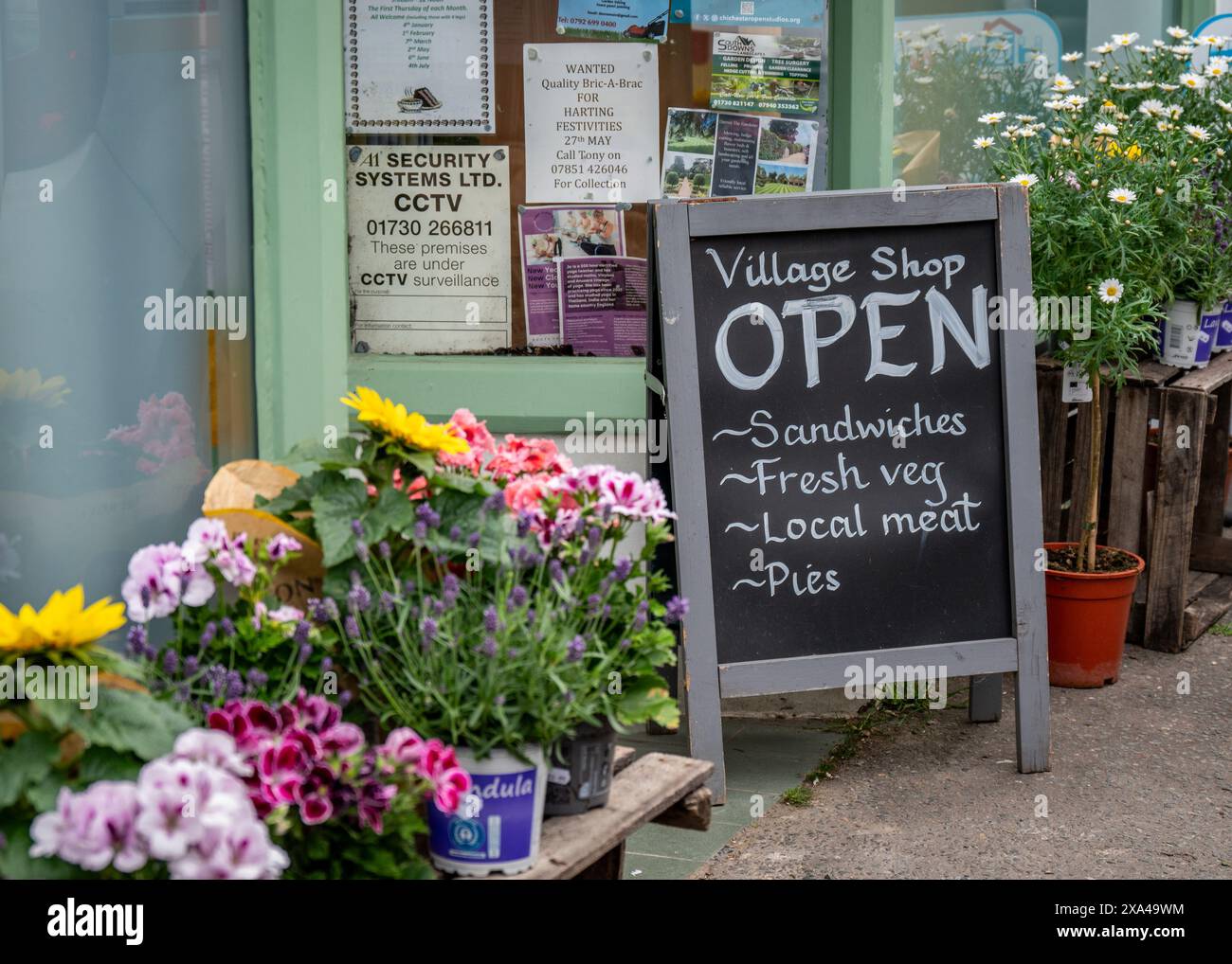 village open shop sign advertising local food and plants for sale Stock ...