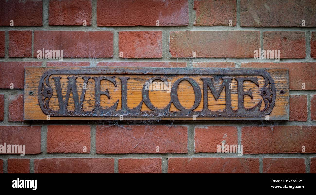 Wooden ornate lettering welcome sign with black lettering attached to a ...
