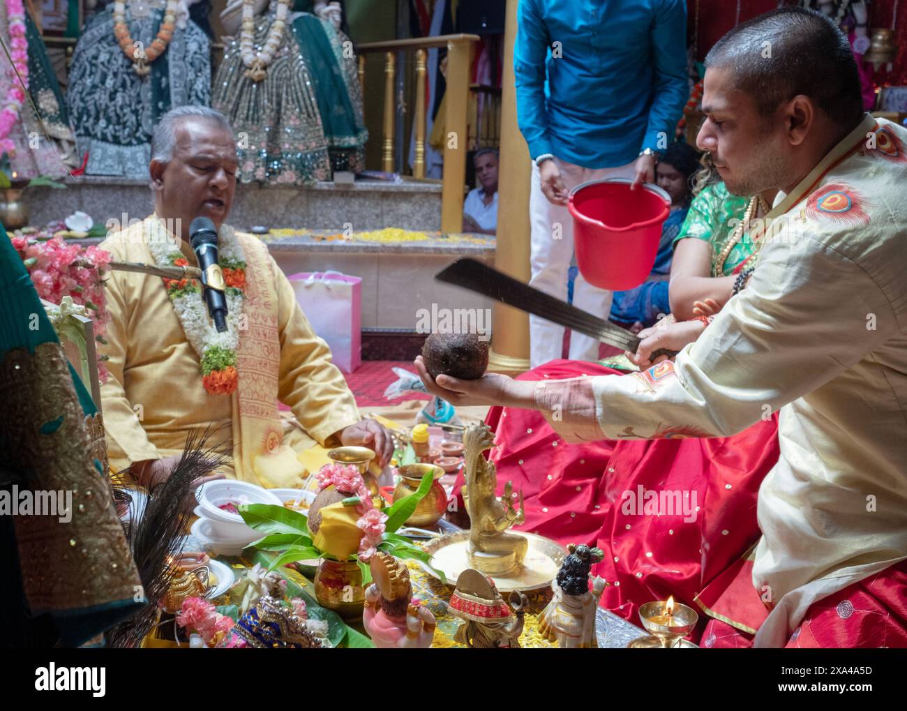 At a Valaikappu service the father to be breaks a coconut, a sacred ...