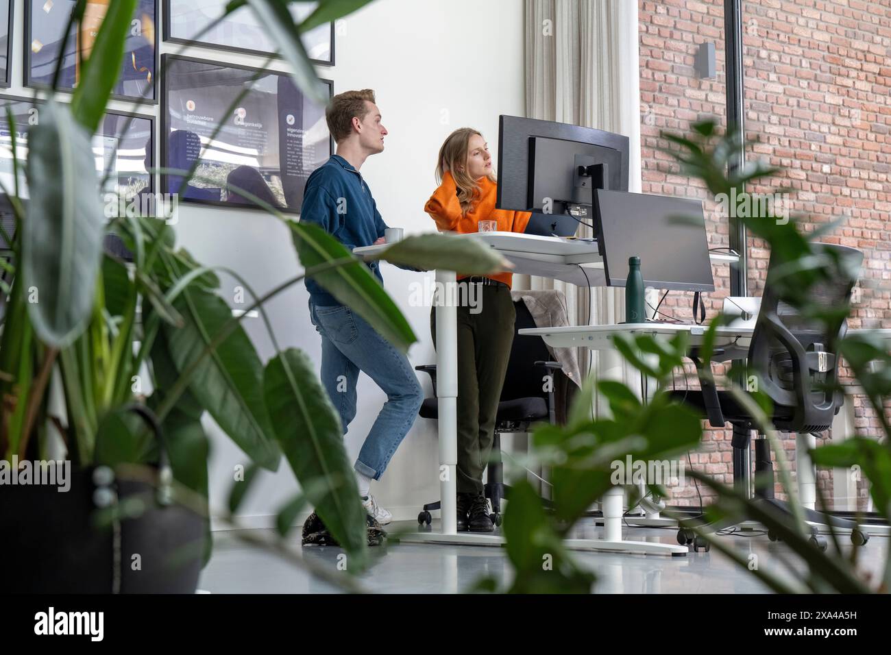 Two professionals are standing side by side modern office environment ...