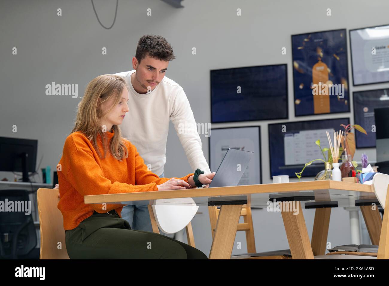 Two professionals are working together desk modern office setting hi ...