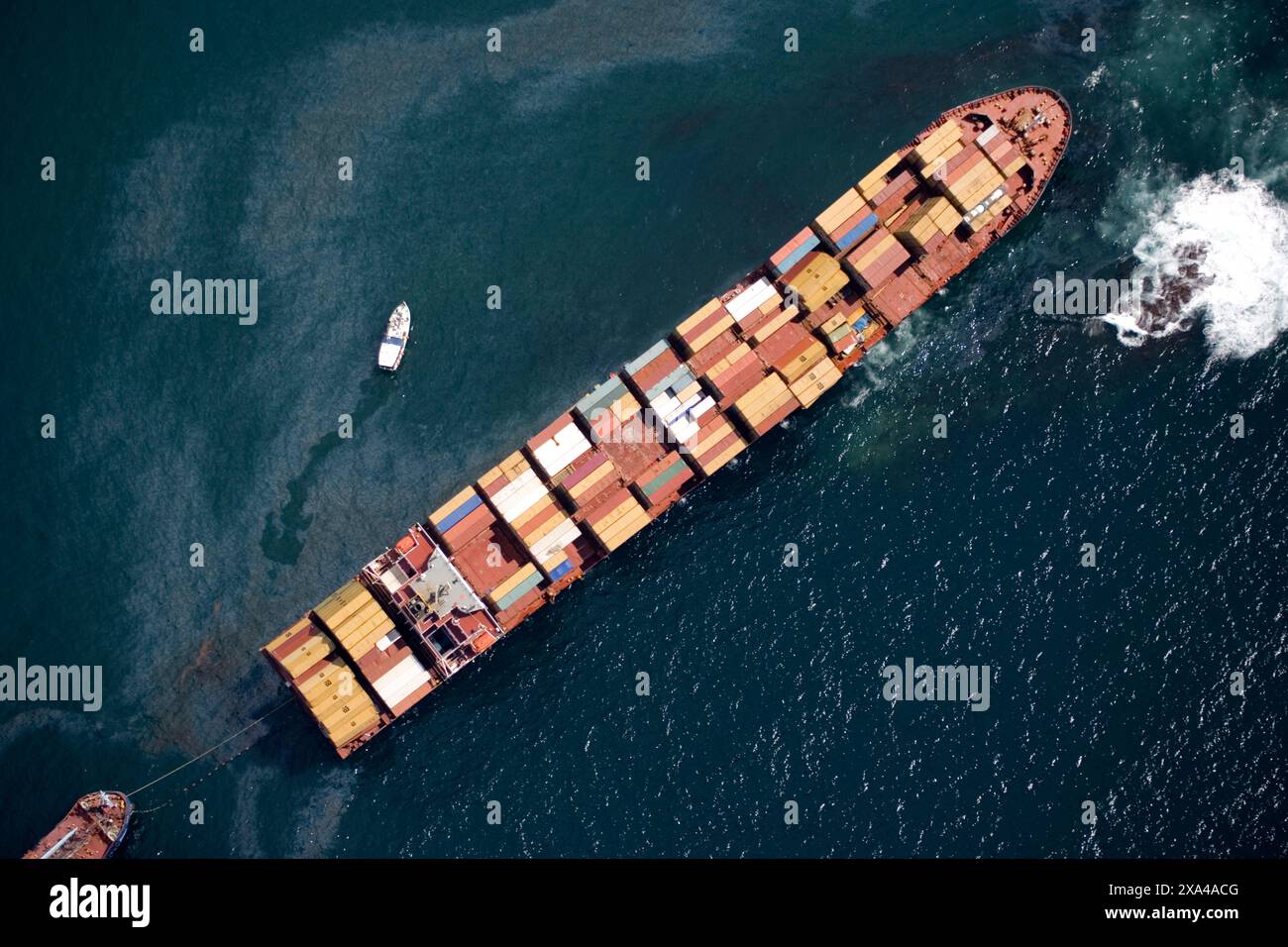 An aerial view of a large cargo ship in trouble at sea, being ...