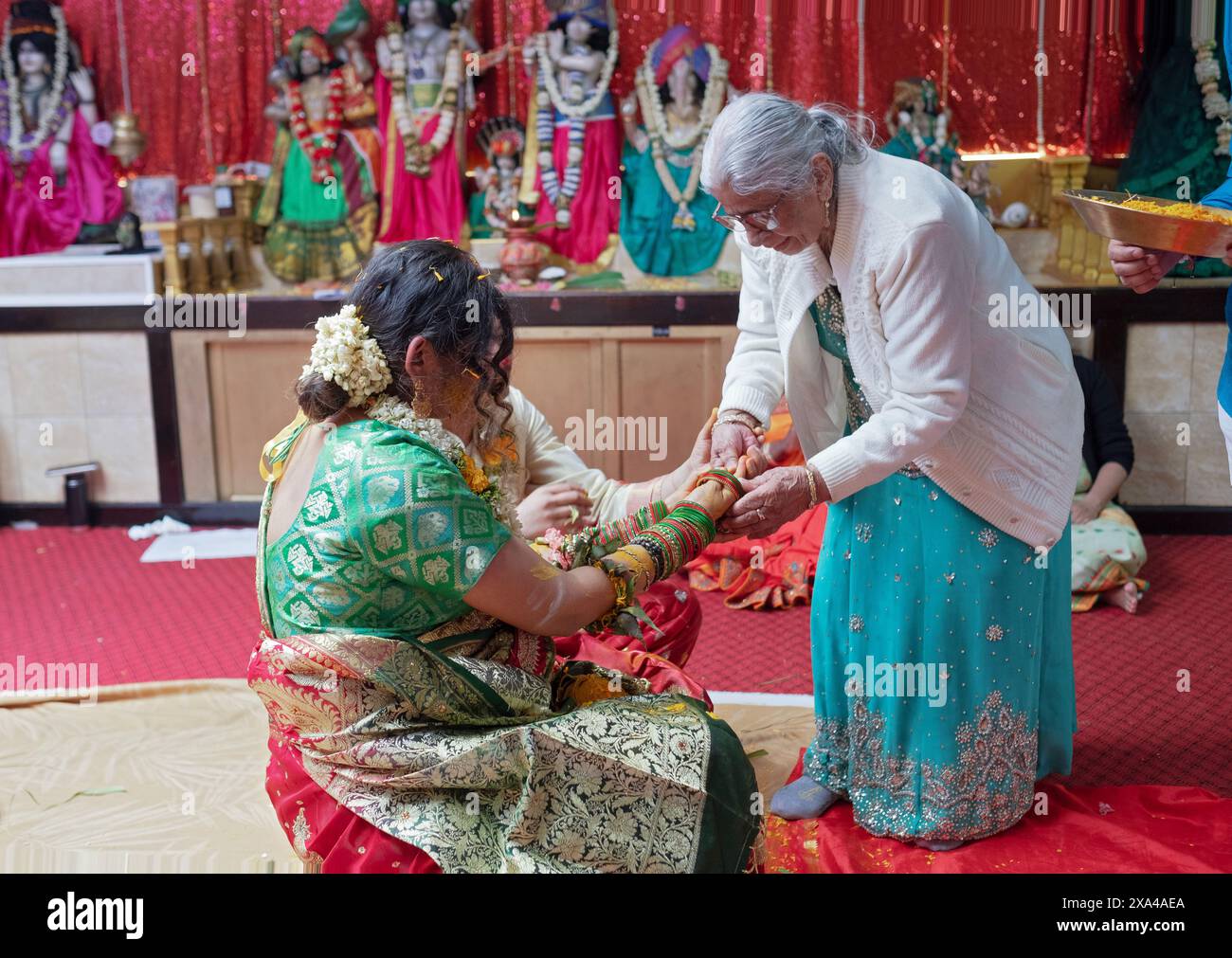 At a Valaikappu service its customary to put bracelets on the wrist of ...