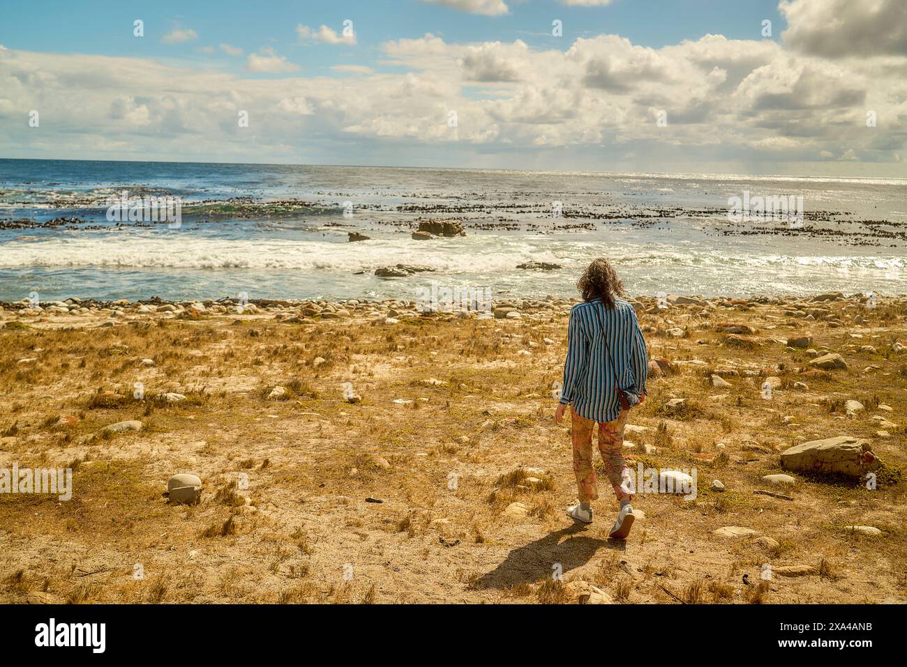Person stands sandy beach looking out ocean hi-res stock photography ...