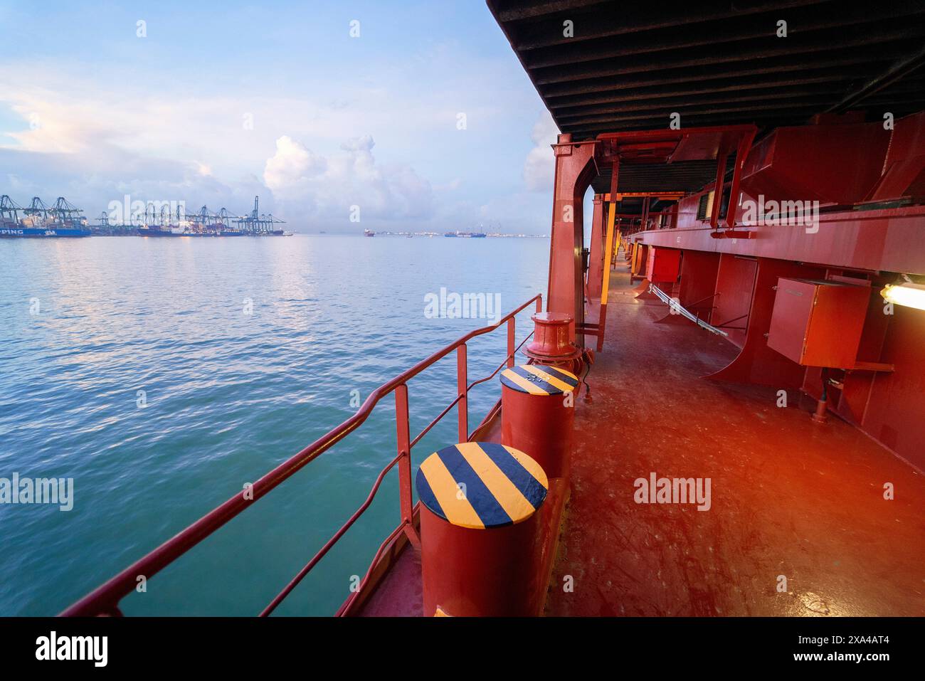 The image captures a vibrant view from the deck of a ship showing red ...