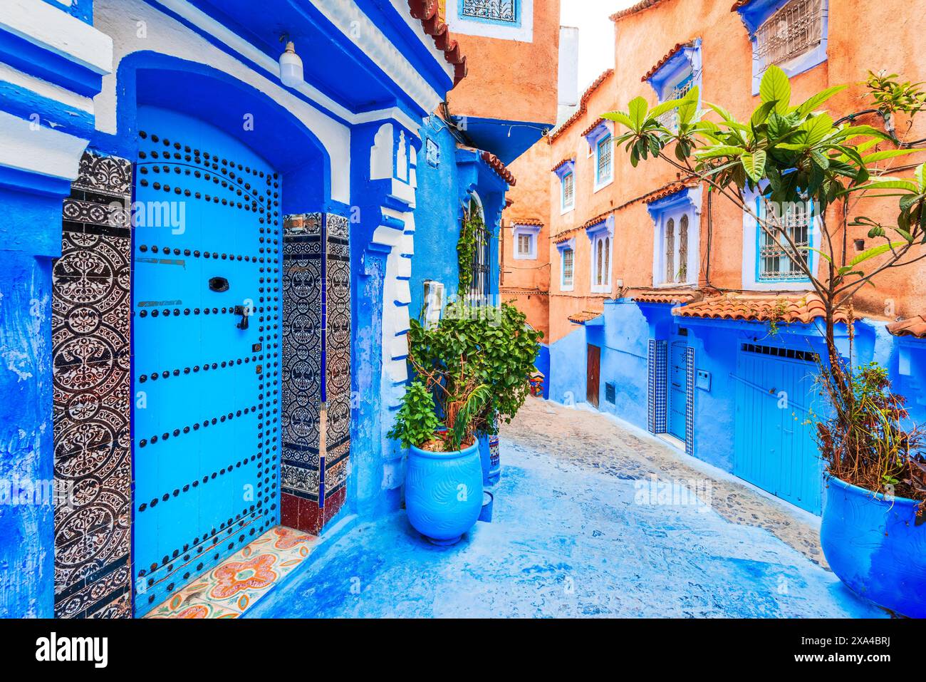 Chefchaouen, Morocco. Blue staircase and wall decorated with colourful ...