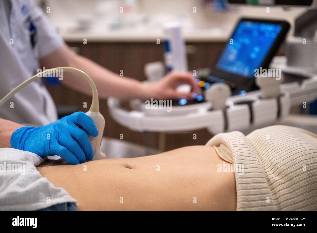 Focus hand holding transducer ultrasound machine screen background hi ...