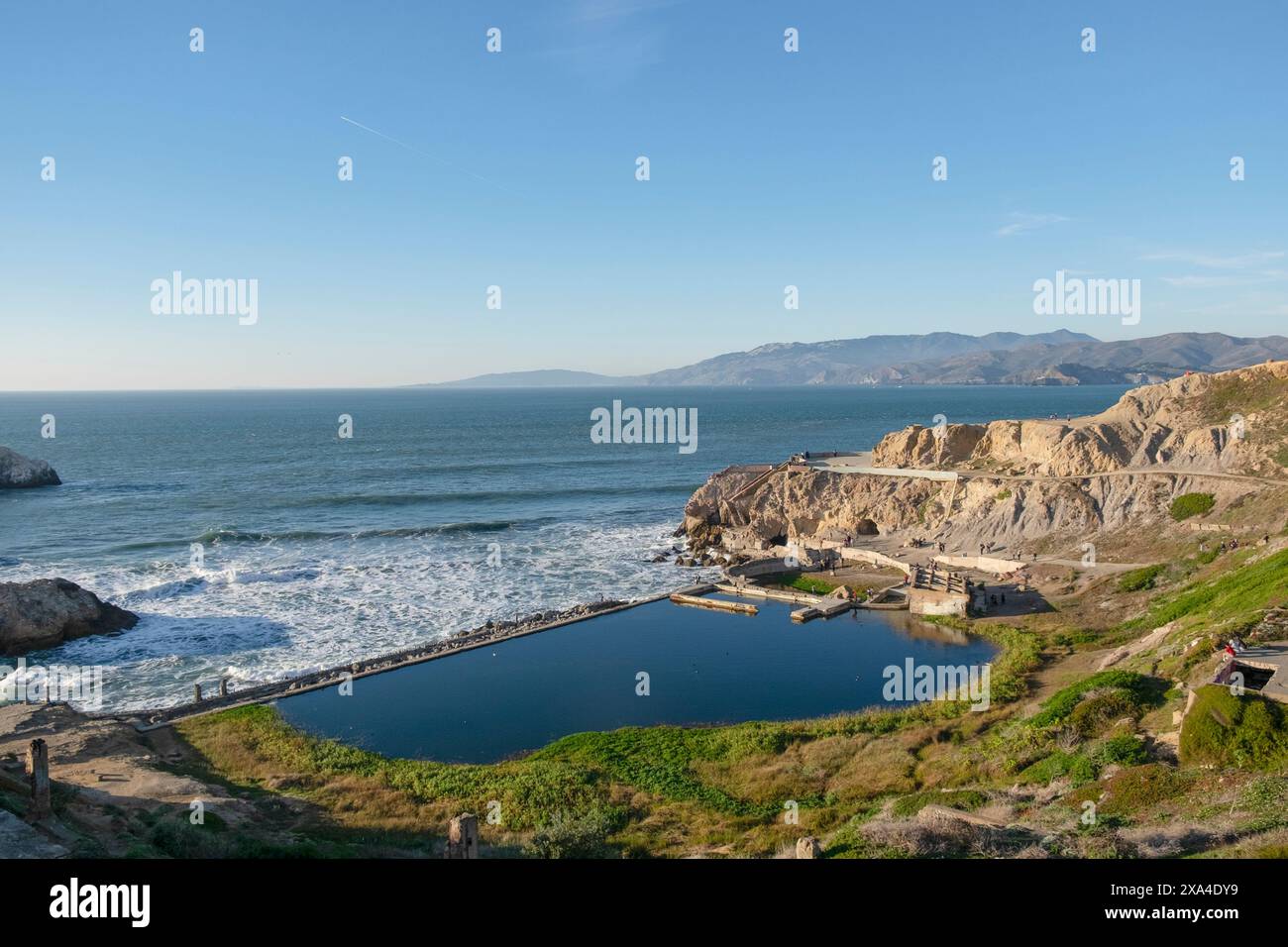 A scenic coastal view featuring a natural pool beside the ocean ...