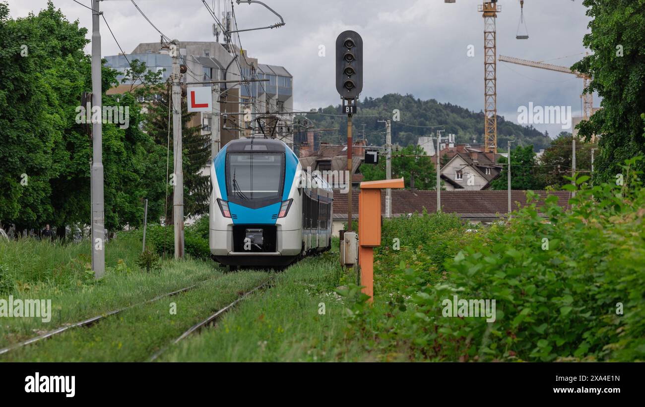 Modern passenger train is driving on poor and neglected train track ...