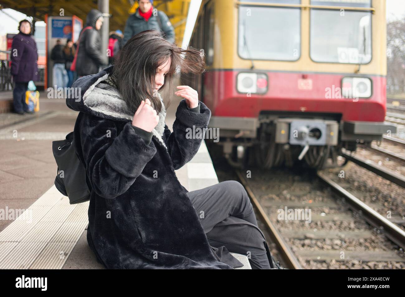 Person sits edge train platform hi-res stock photography and images - Alamy