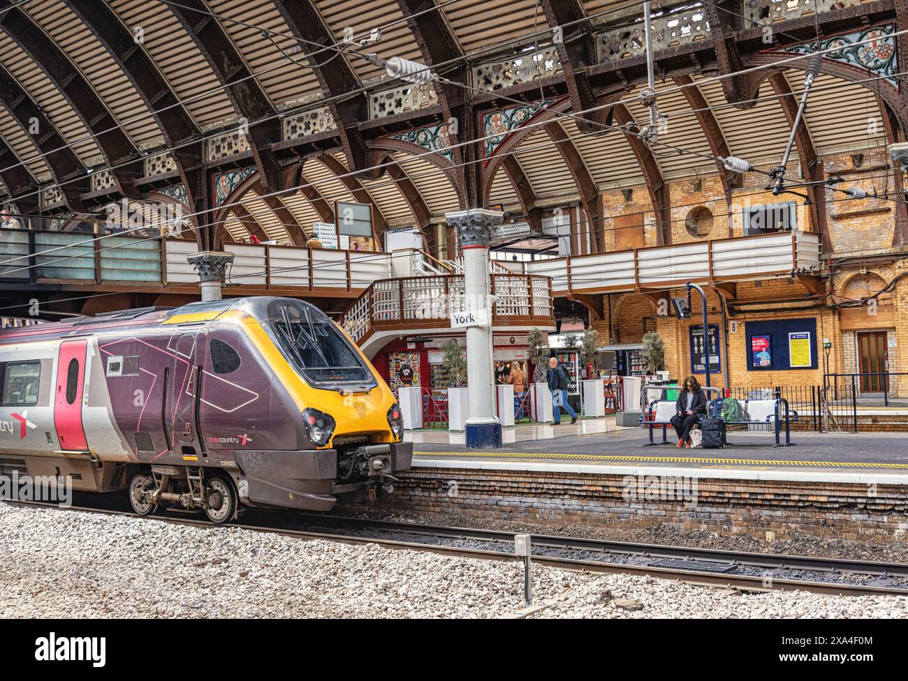 A train rests by a historic 19th Century railway station platform. A ...