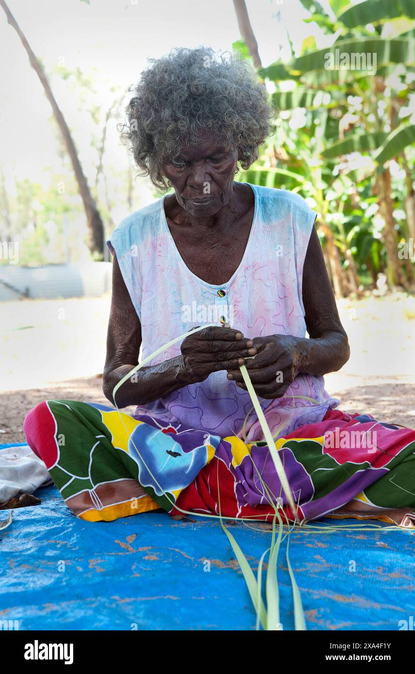 A woman, Aboriginal elder, weaving baskets, Nyinyikay Homeland, East ...