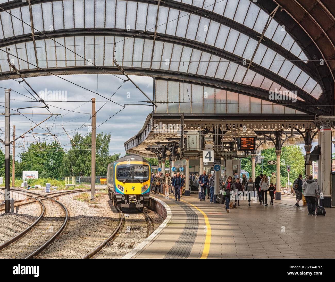 A train has just arrived at a railway station platform and passengers ...