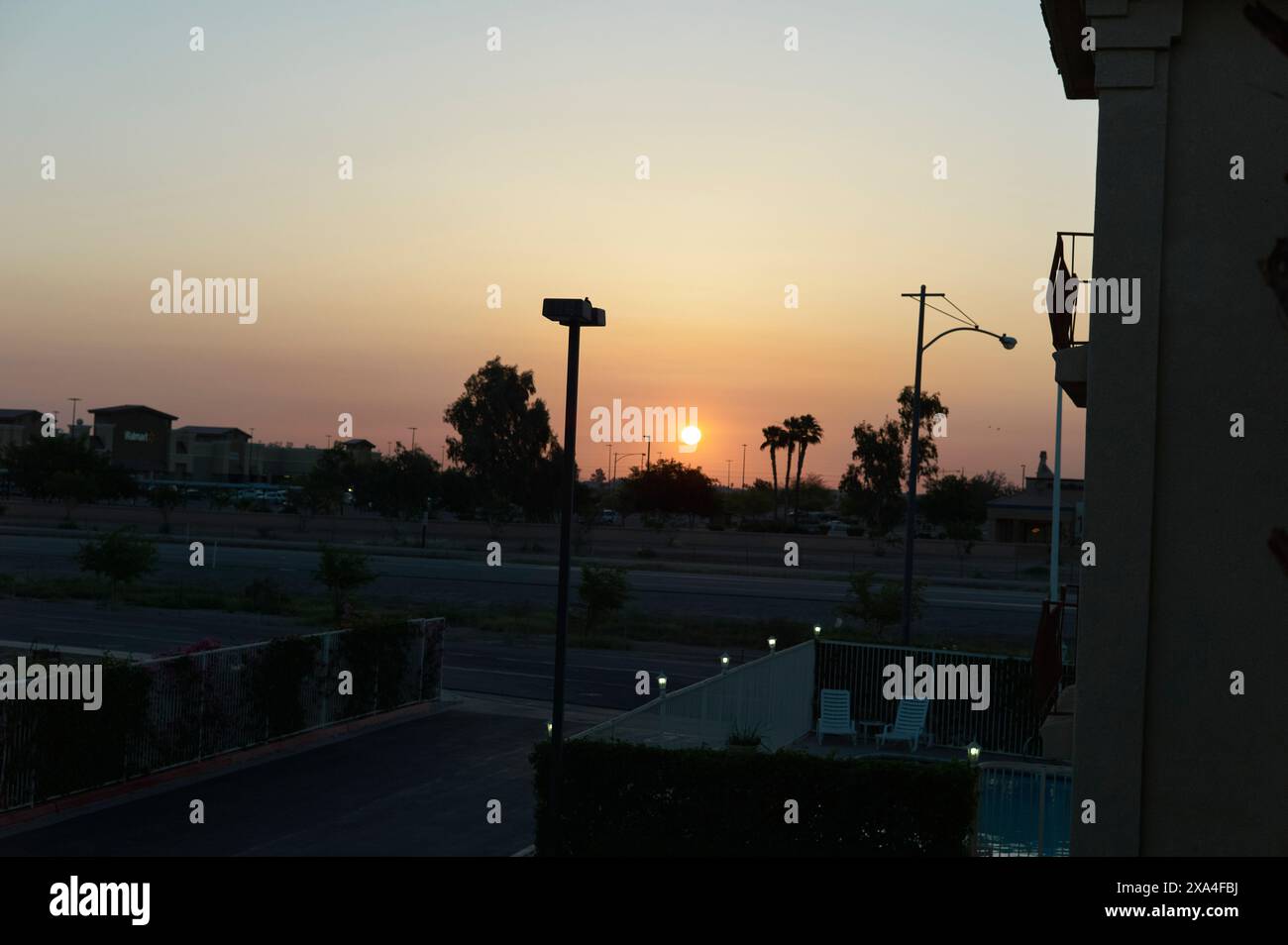 Sunset view from a balcony with the sun dipping low on the horizon ...