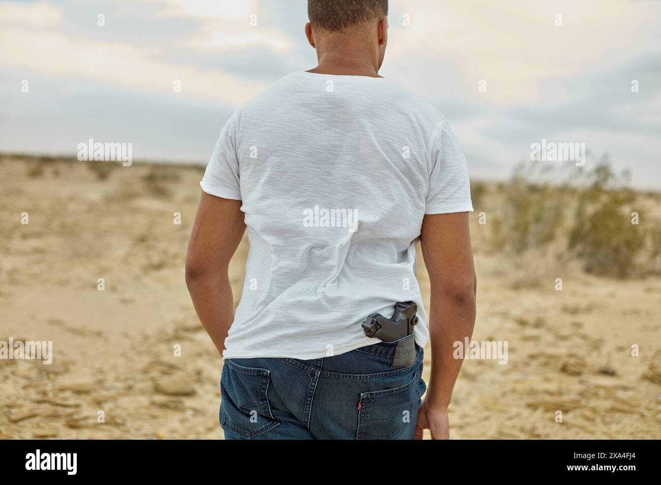 Man white t shirt blue jeans stands desert landscape hi-res stock ...