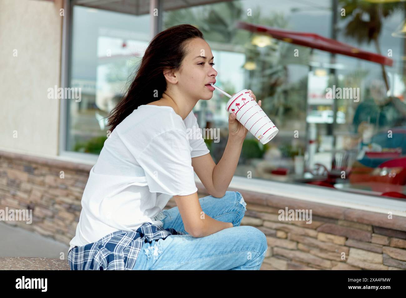 Woman sipping through straw hi-res stock photography and images - Alamy