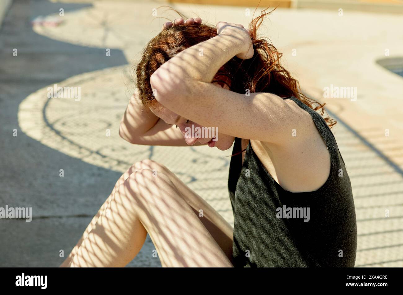 Woman shielding face from sun hi-res stock photography and images - Alamy