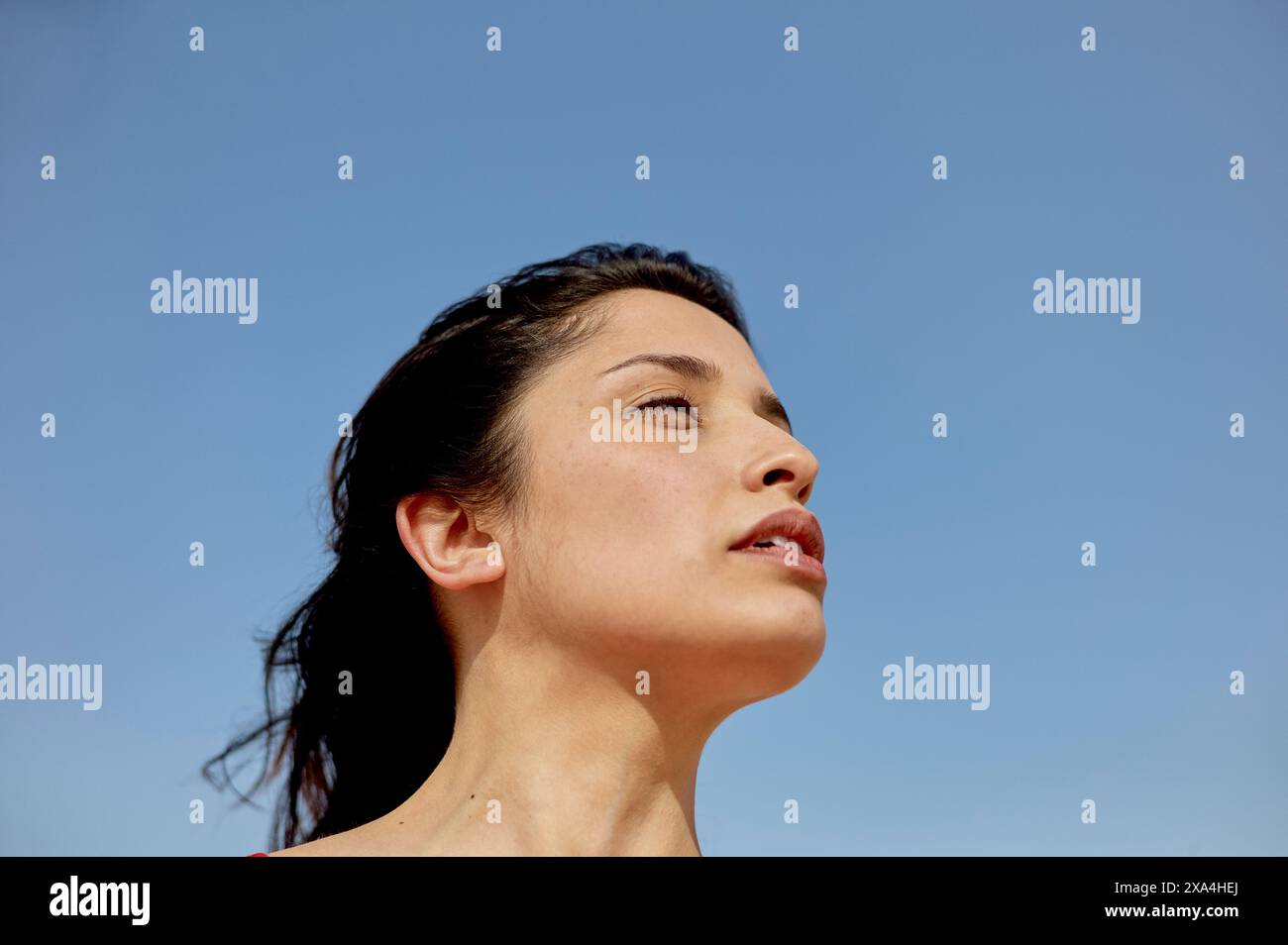 Woman gazes upward clear blue sky hi-res stock photography and images ...