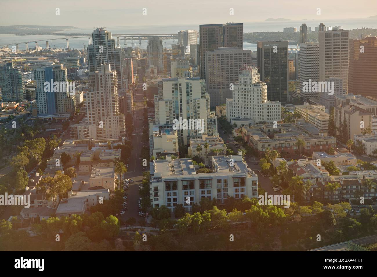 An aerial view of a cityscape at sunset, showcasing a mix of high-rise ...