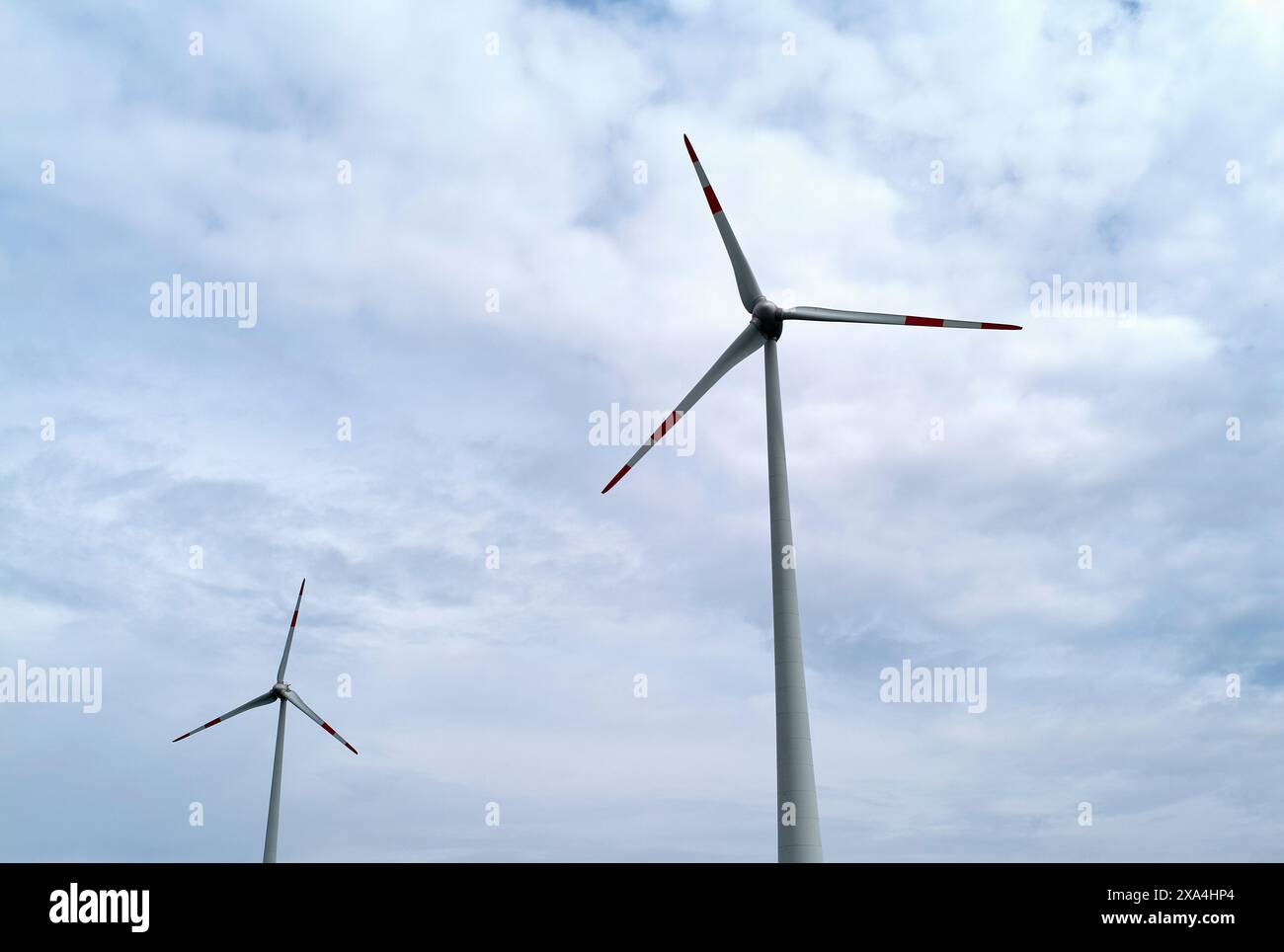 Two wind turbines stand tall cloudy sky hi-res stock photography and ...