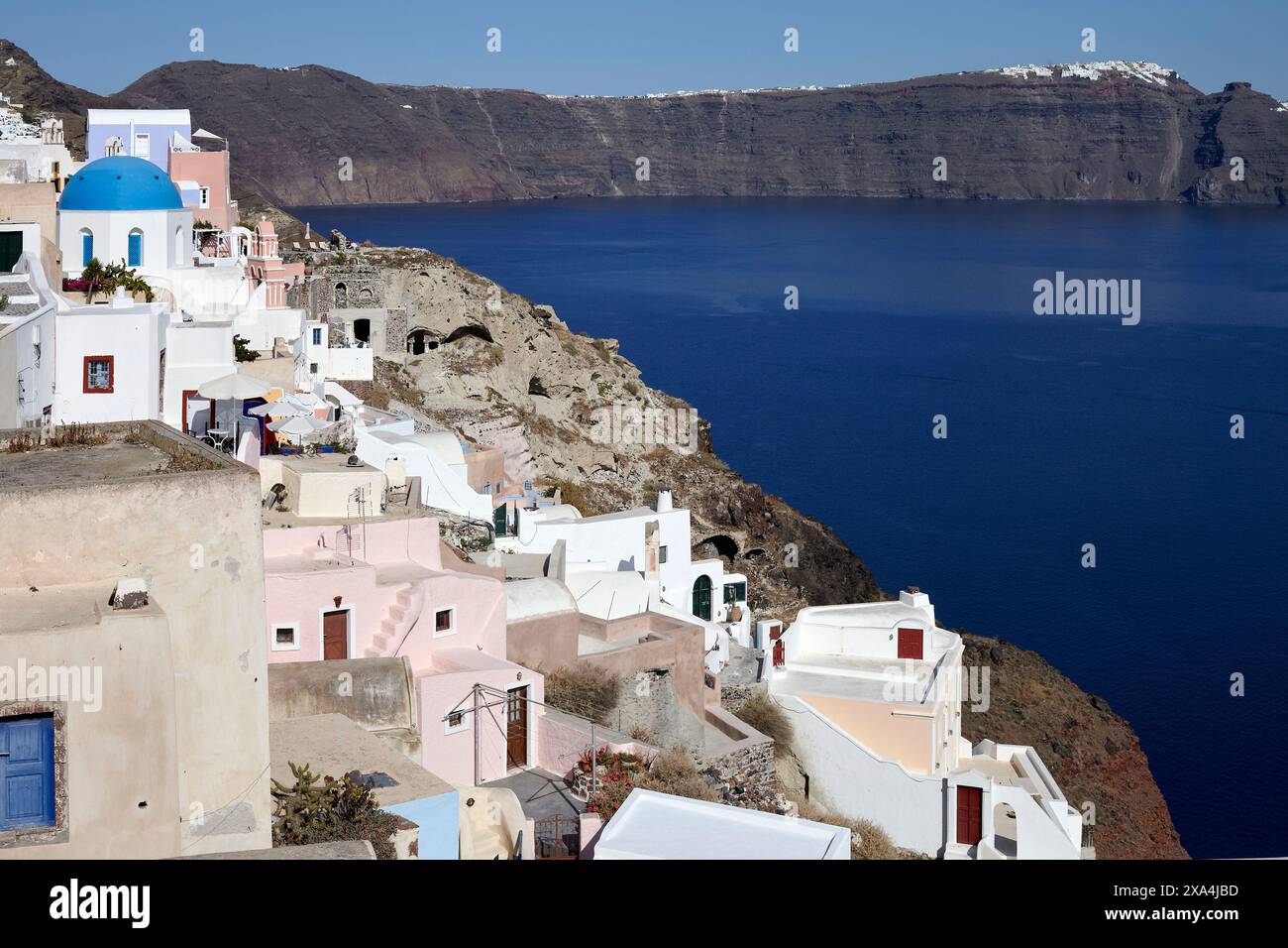 A scenic view of Oia, Santorini, with its iconic white buildings, blue ...