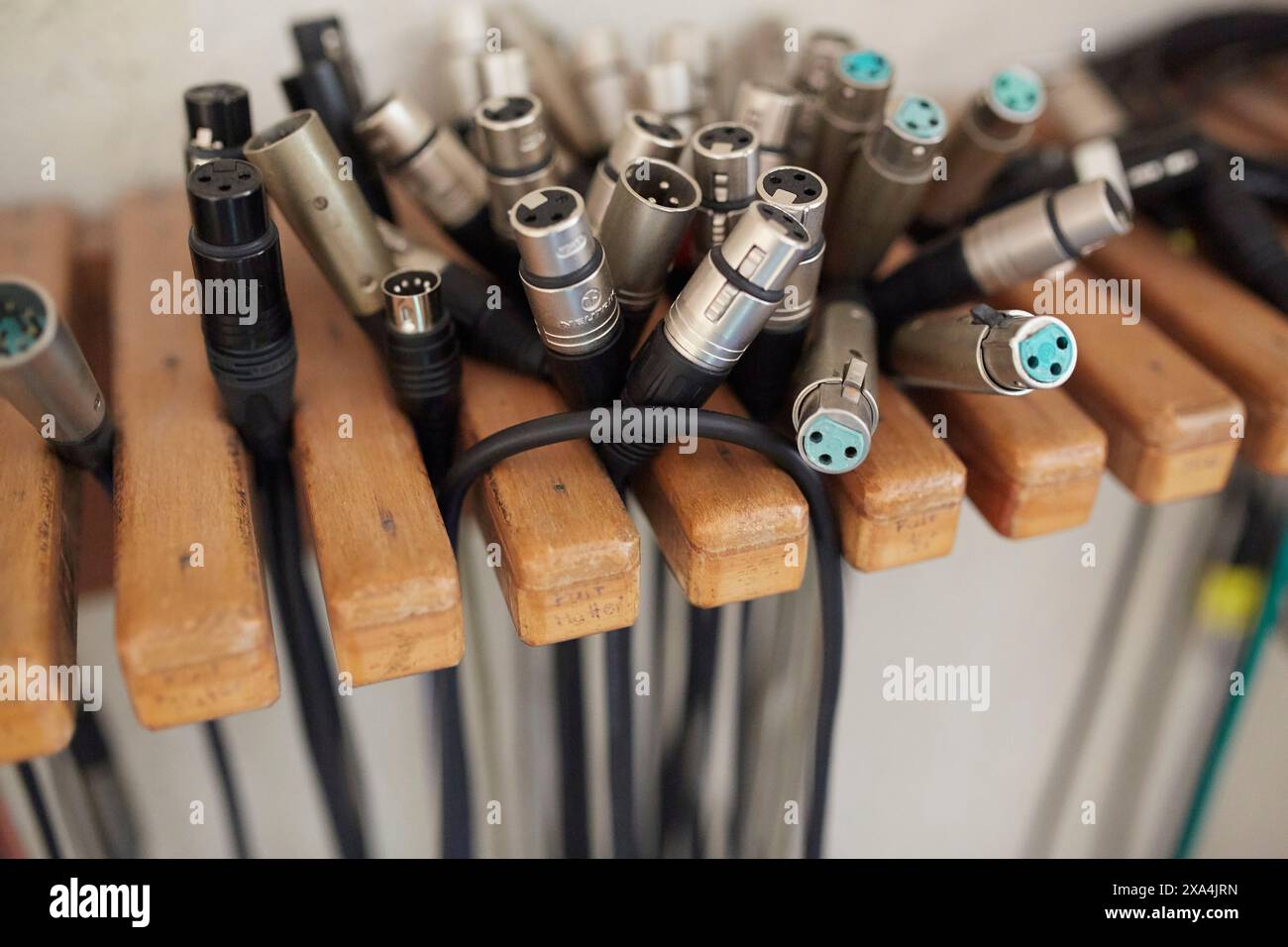 An assortment of audio cables with various connectors is neatly ...