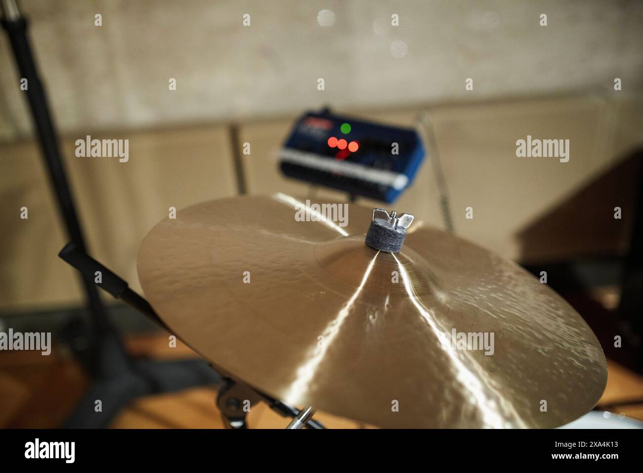 A close-up of a shiny cymbal as part of a drum set with a music ...