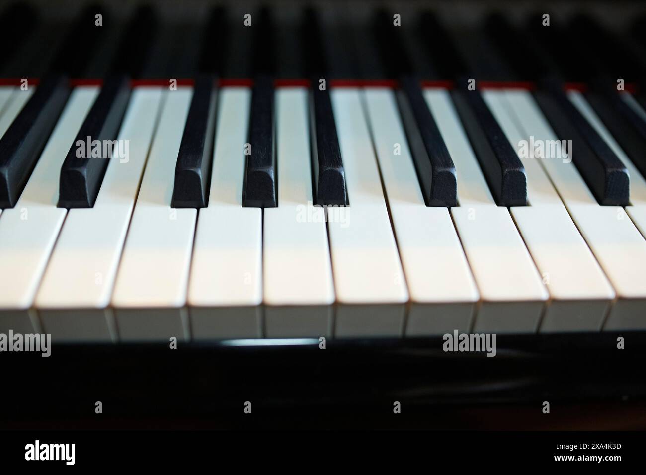 A close-up view of black and white piano keys showing their pattern and ...