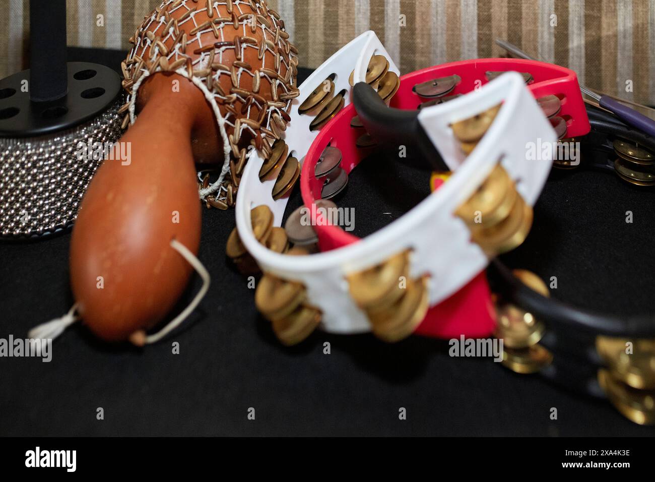 A collection of musical percussion instruments, including a shekere ...