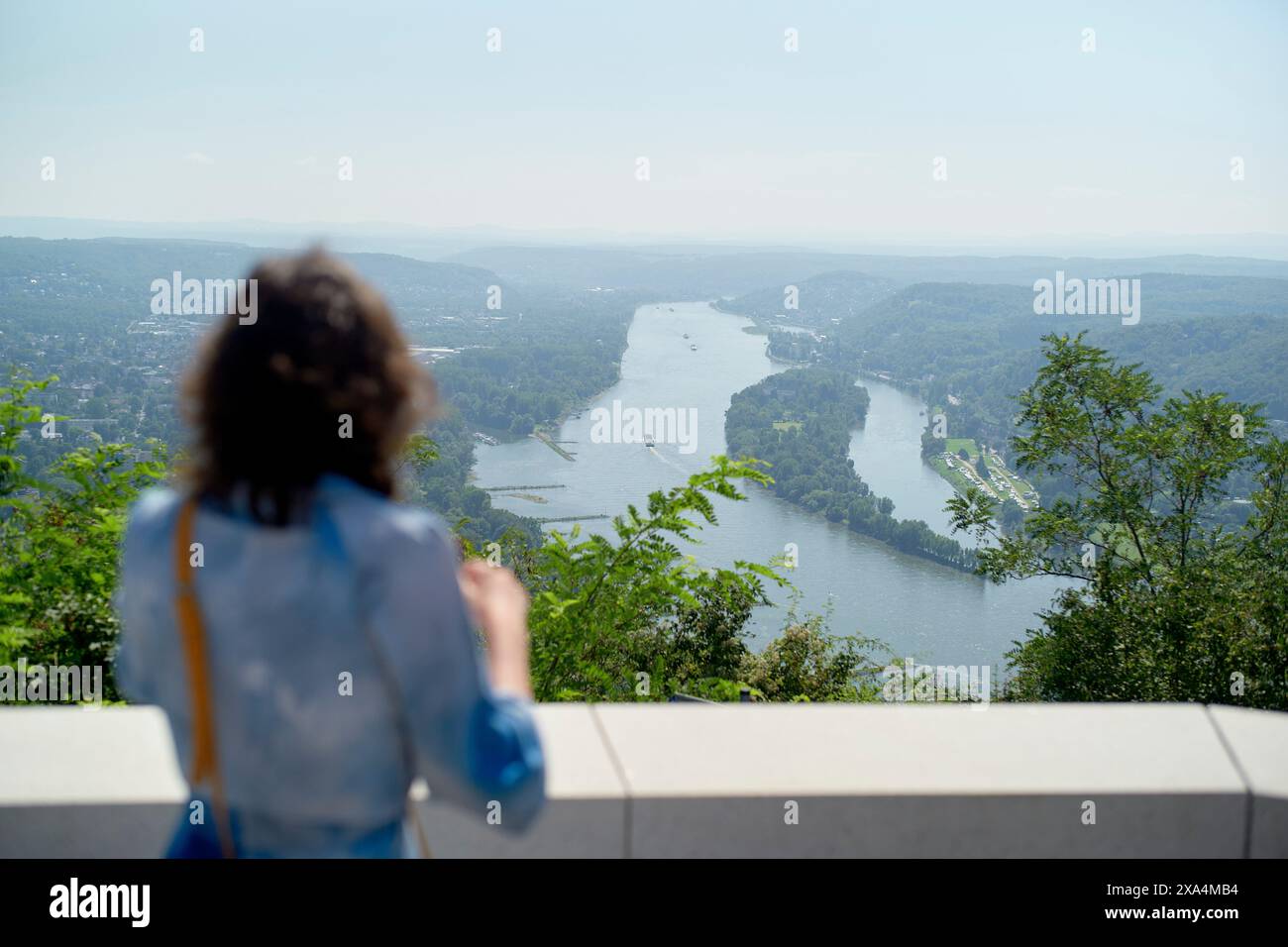 A person stands overlooking a scenic river landscape from a high ...