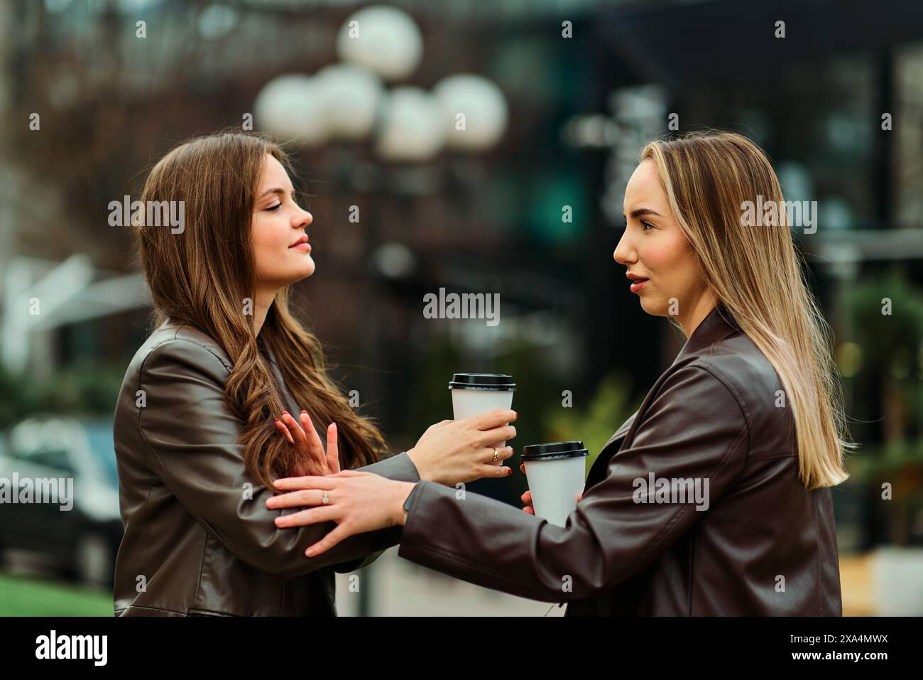 Two businesswomen enjoying a coffee break outside their office Stock ...