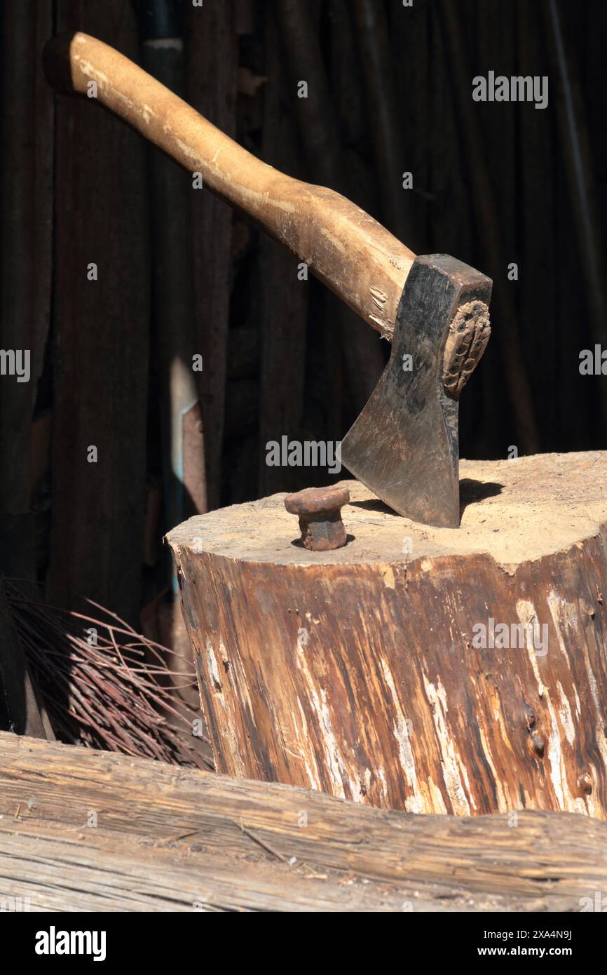 The ax is hammered into a wooden deck. Next is a hammered anvil for ...
