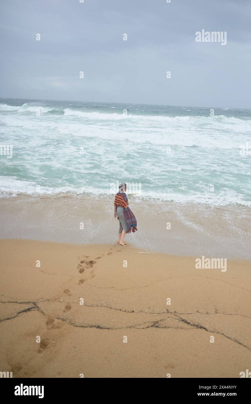 Looking waves footprints trailing behind them hi-res stock photography ...
