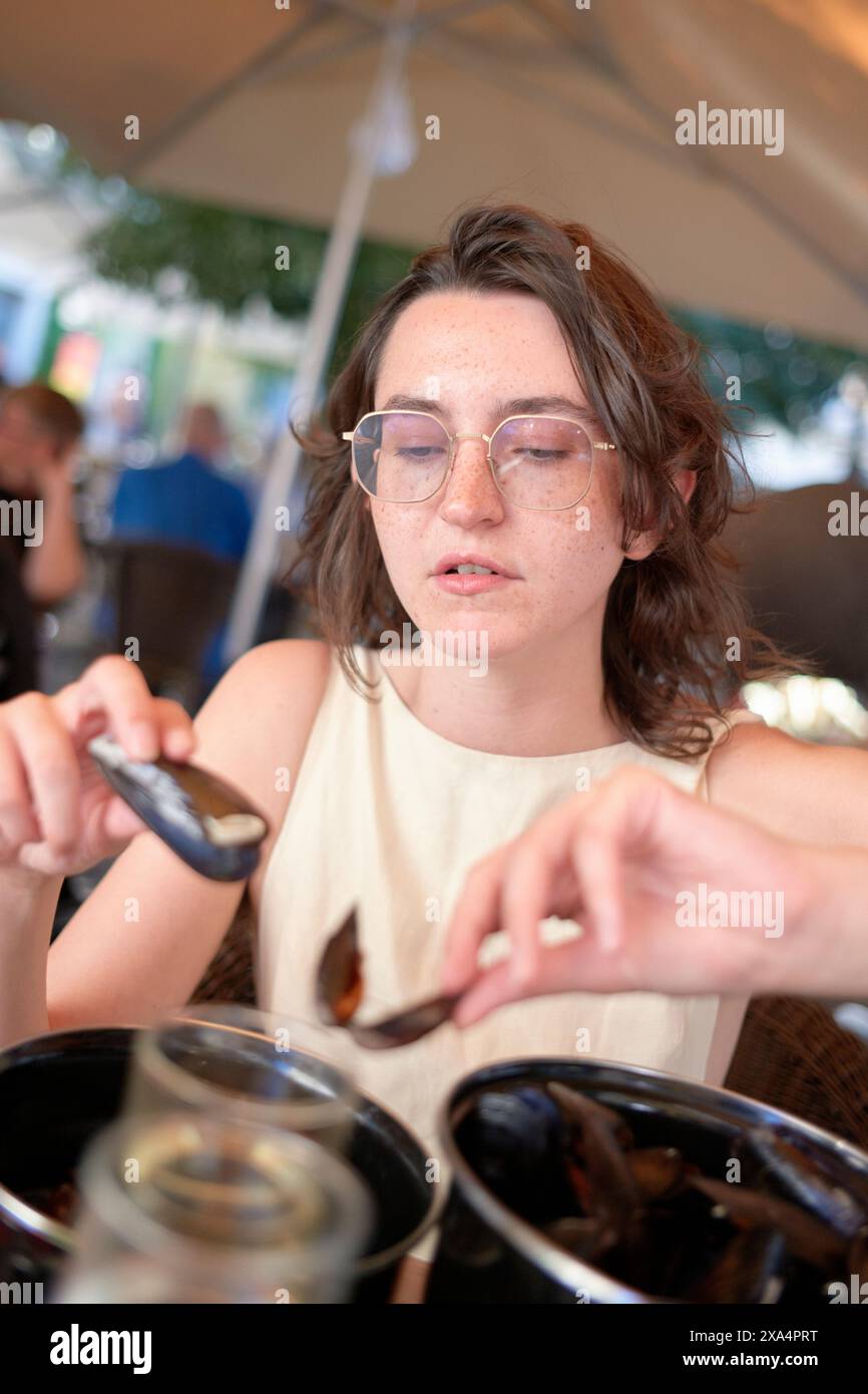 Holding utensils focusing dish mussels front them hi-res stock ...