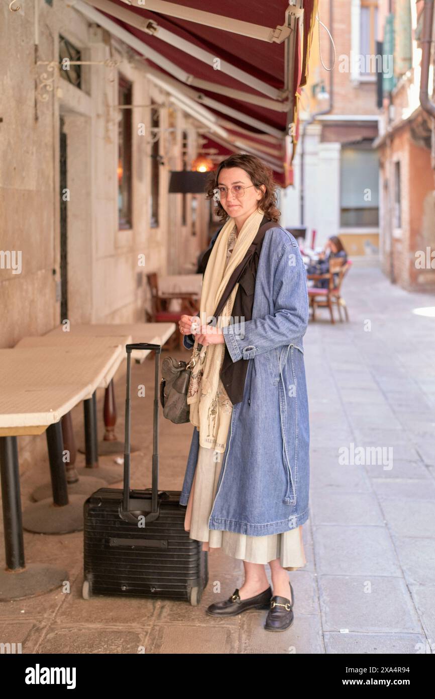 Woman standing quaint alley suitcase hi-res stock photography and ...