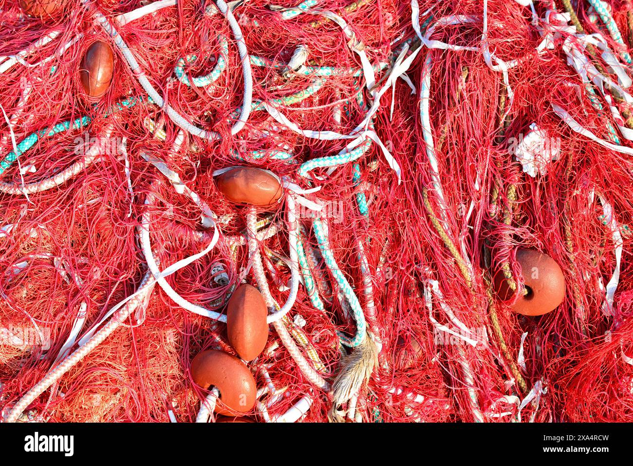 Red fishing net, orange floats and ropes in daytime Stock Photo - Alamy
