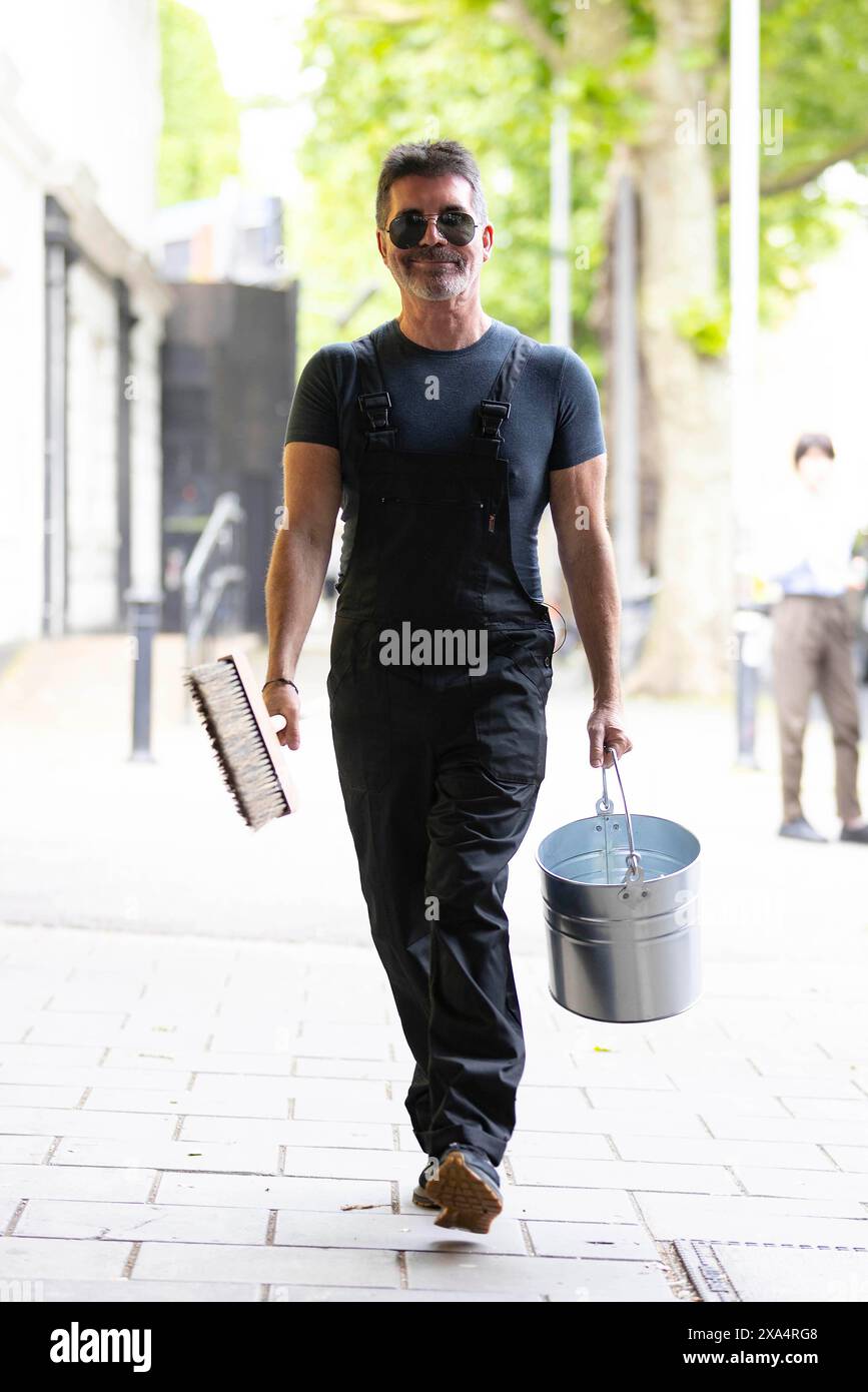 EDITORIAL USE ONLY Simon Cowell 'installs' a billboard in London as he ...