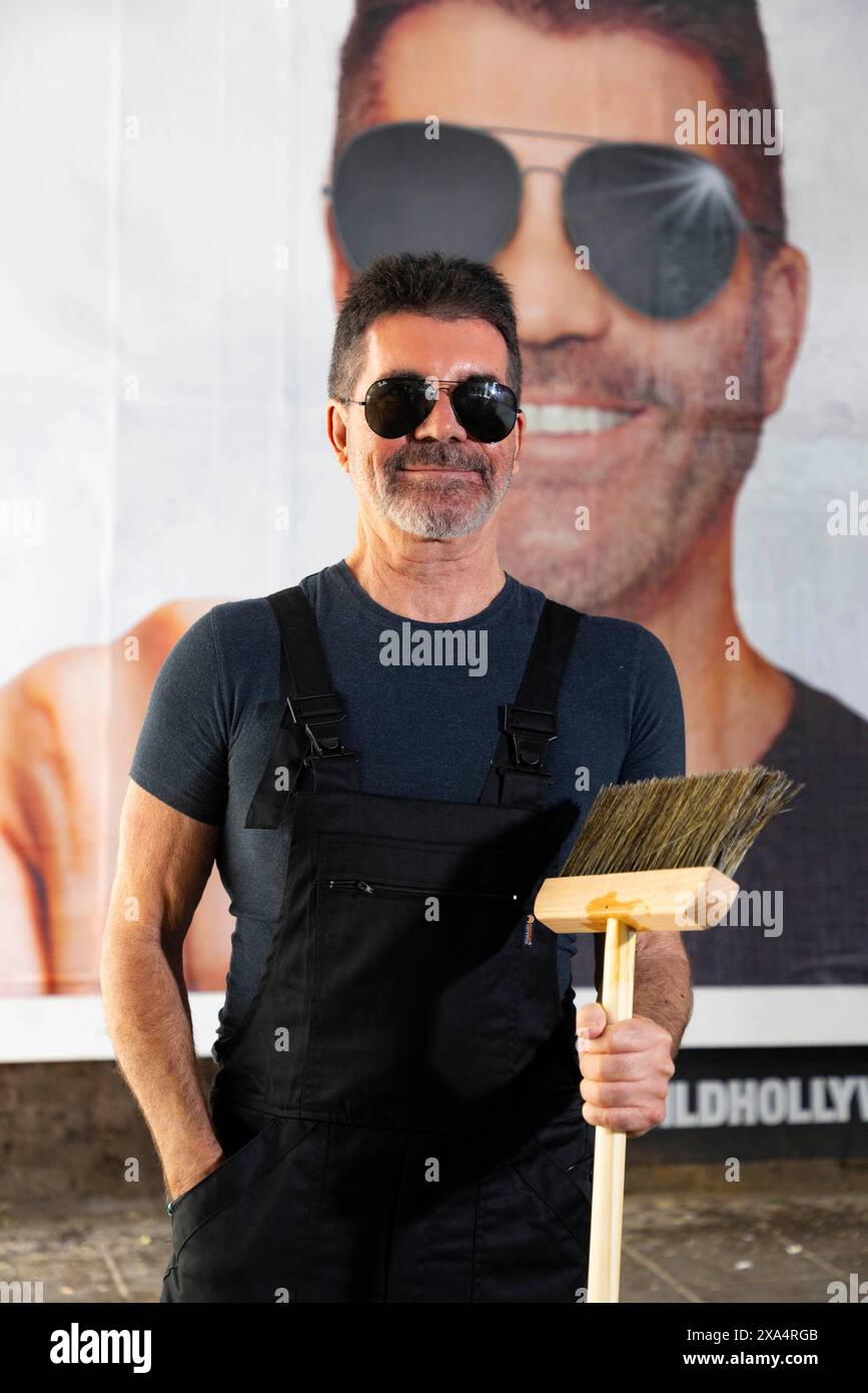 EDITORIAL USE ONLY Simon Cowell 'installs' a billboard in London as he ...