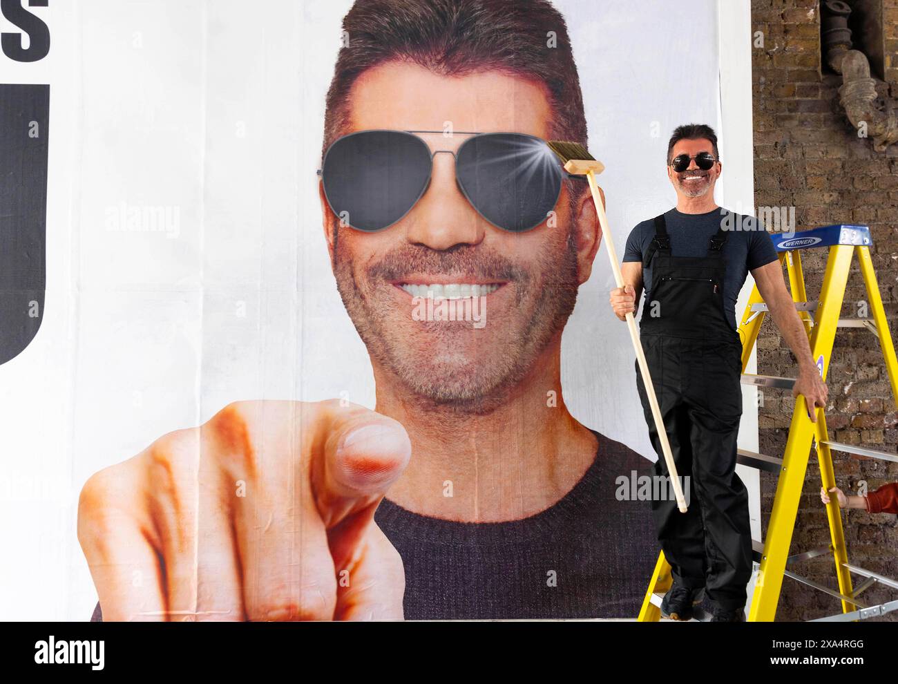 EDITORIAL USE ONLY Simon Cowell 'installs' a billboard in London as he ...