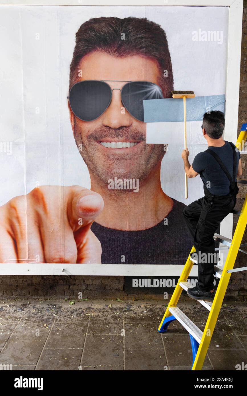 EDITORIAL USE ONLY Simon Cowell 'installs' a billboard in London as he ...