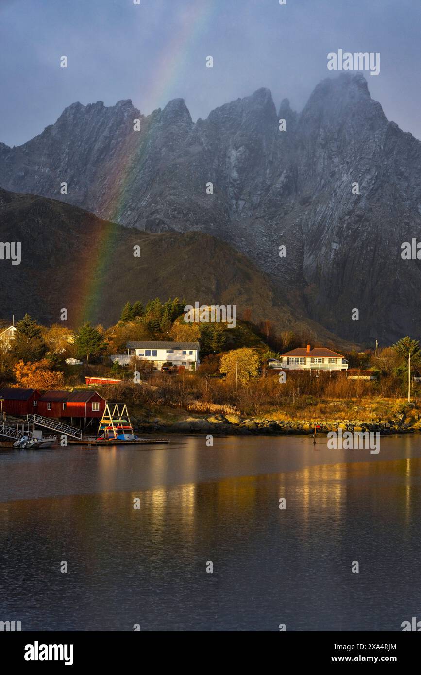 Mountains and rainbow from Ballstad harbour during sunrise, Vestvagoy ...