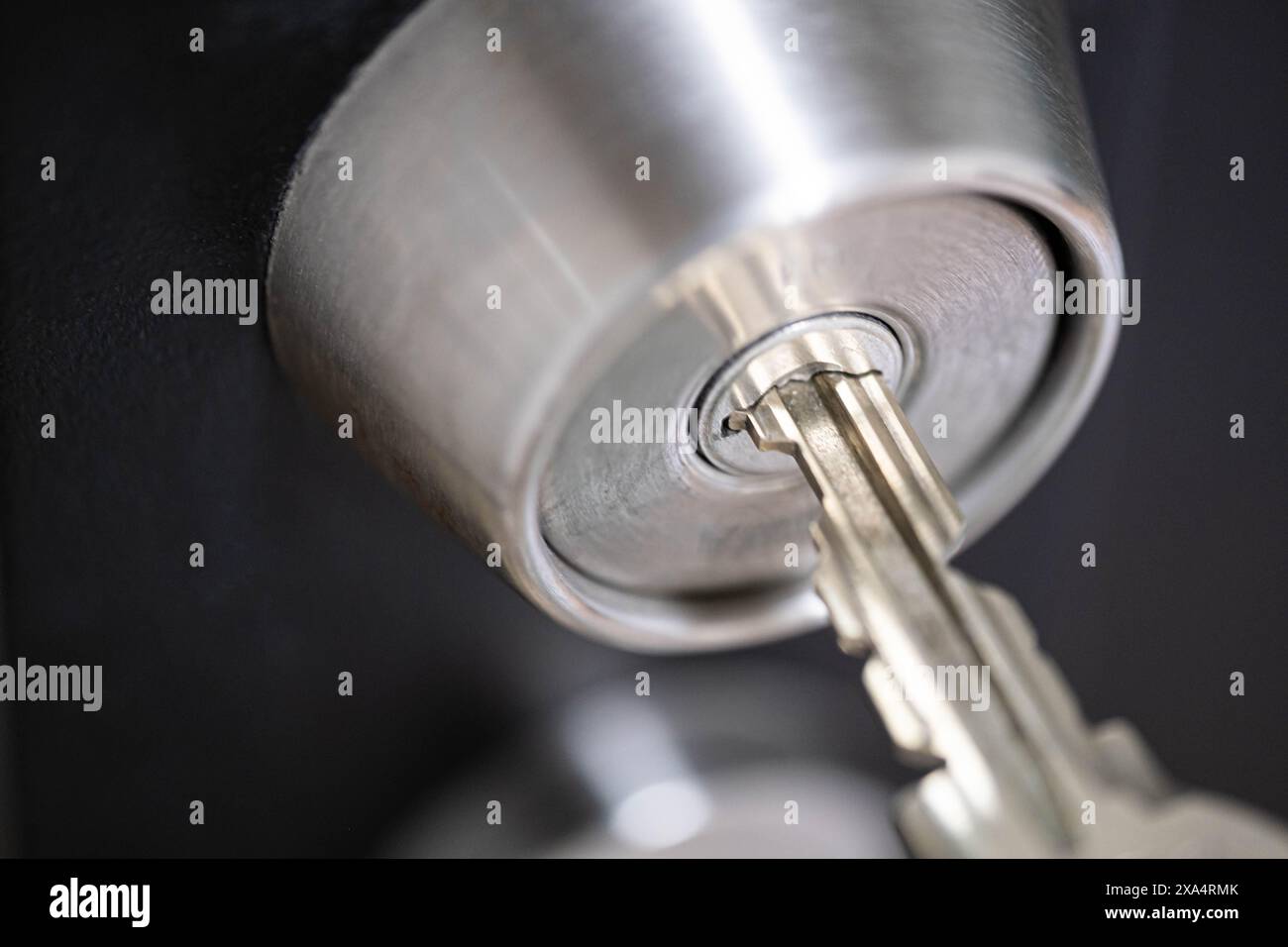 Close-up of a key inserted into a door lock, focusing on the key and ...