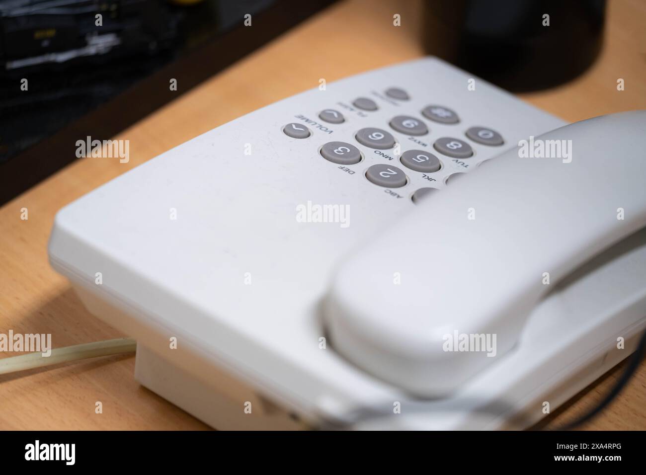 A close-up view of a white landlines telephone with a numeric keypad on ...