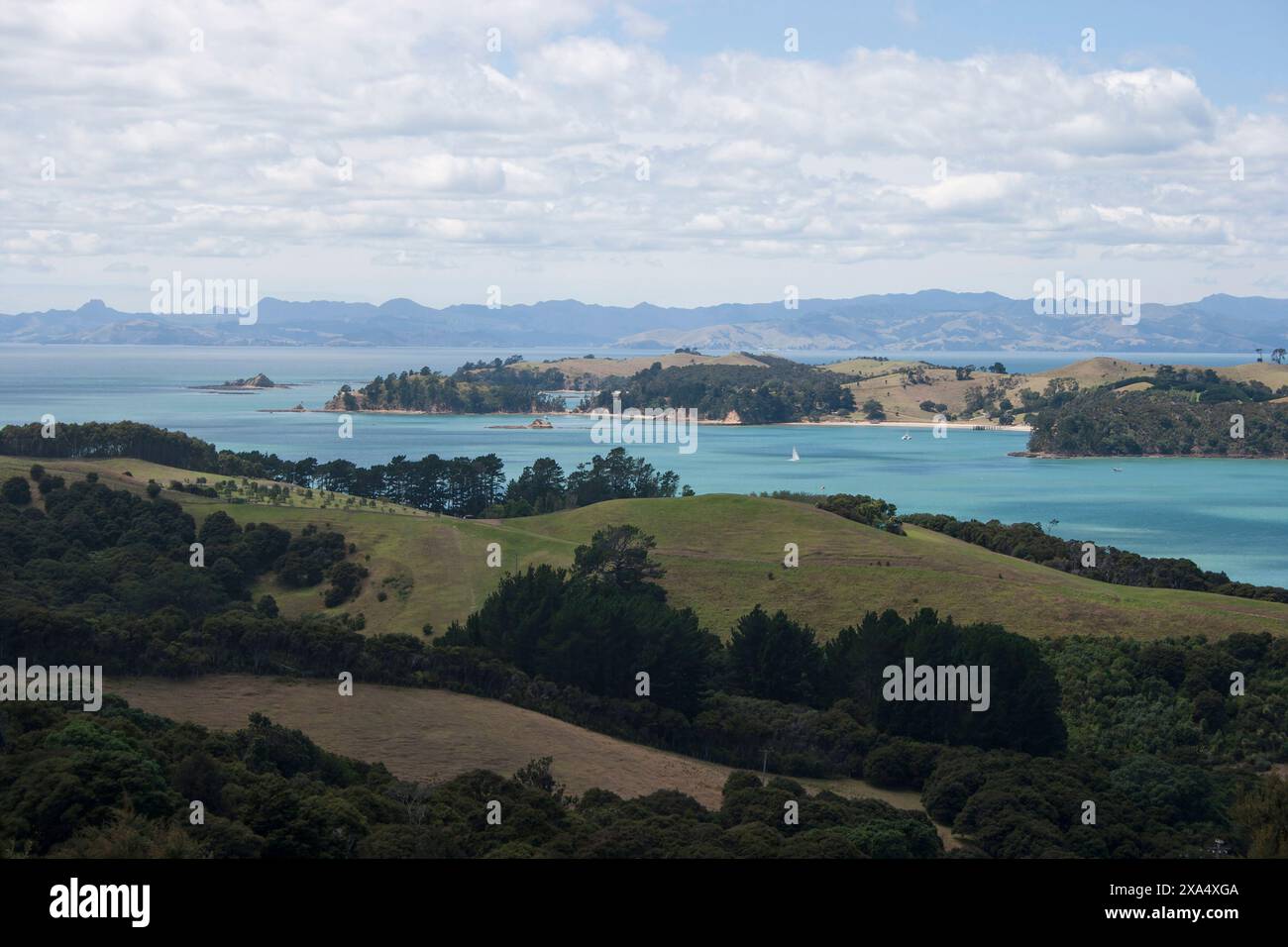 Scenic coastal landscape with rolling hills and clear blue waters under ... Scenic coastal landscape with rolling hills and clear blue waters under ...