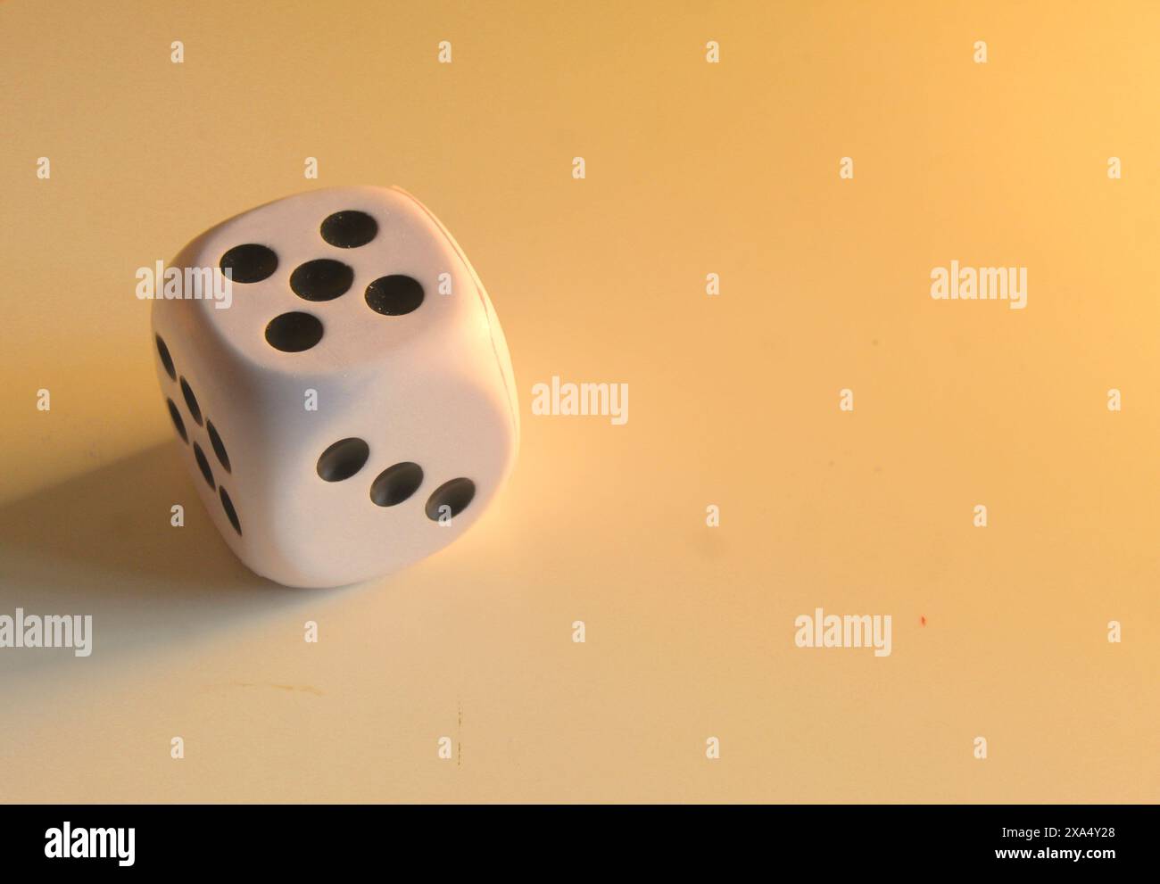 In this captivating image, a six-sided die is caught mid-roll ...