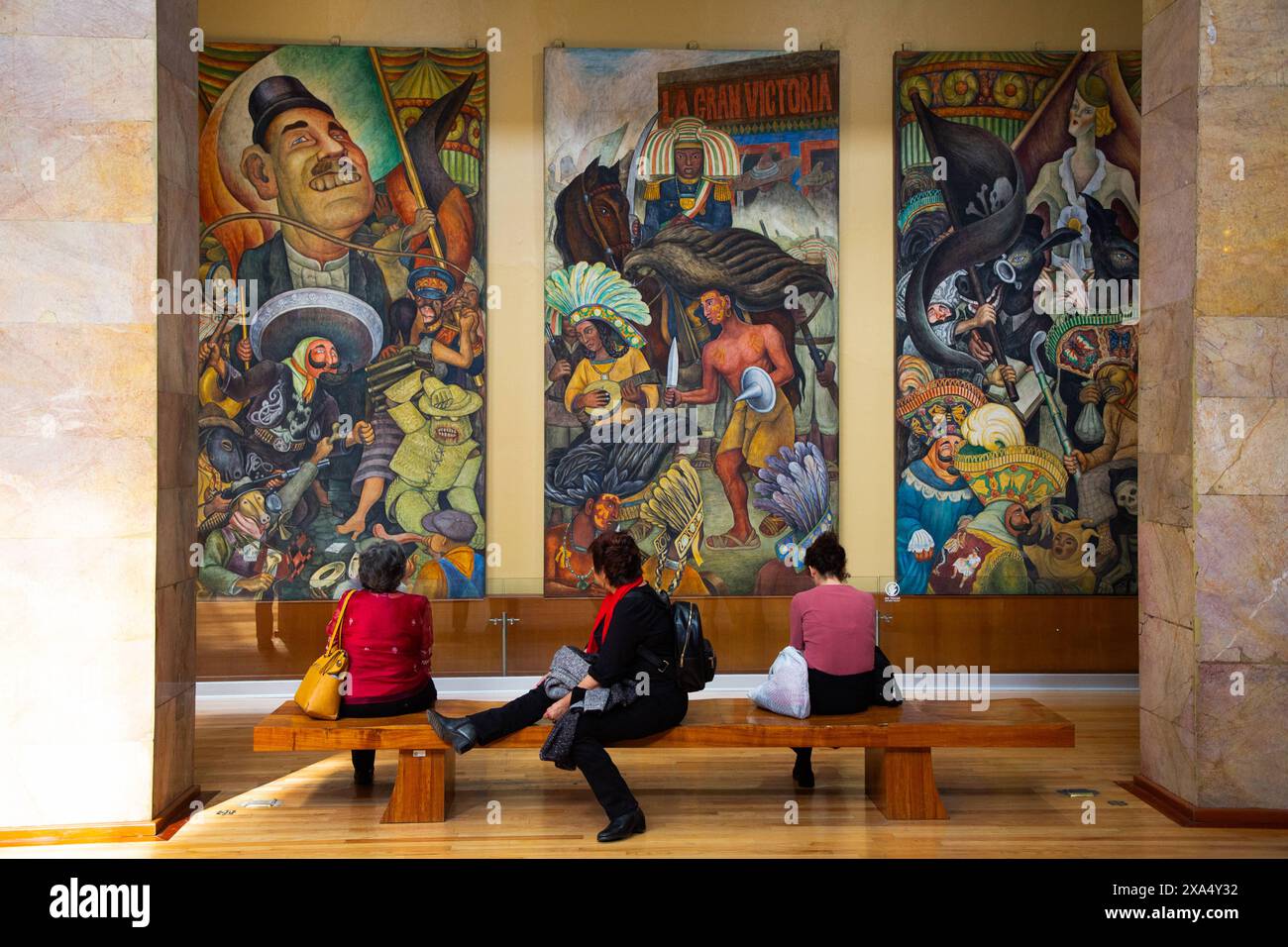 Tourists viewing frescoes by Diego Rivera, Palacio de Bellas Artes ...