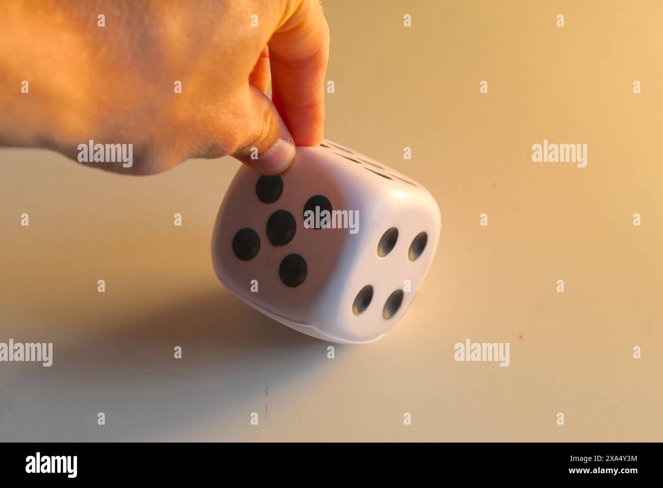 In this captivating image, a six-sided die is caught mid-roll ...