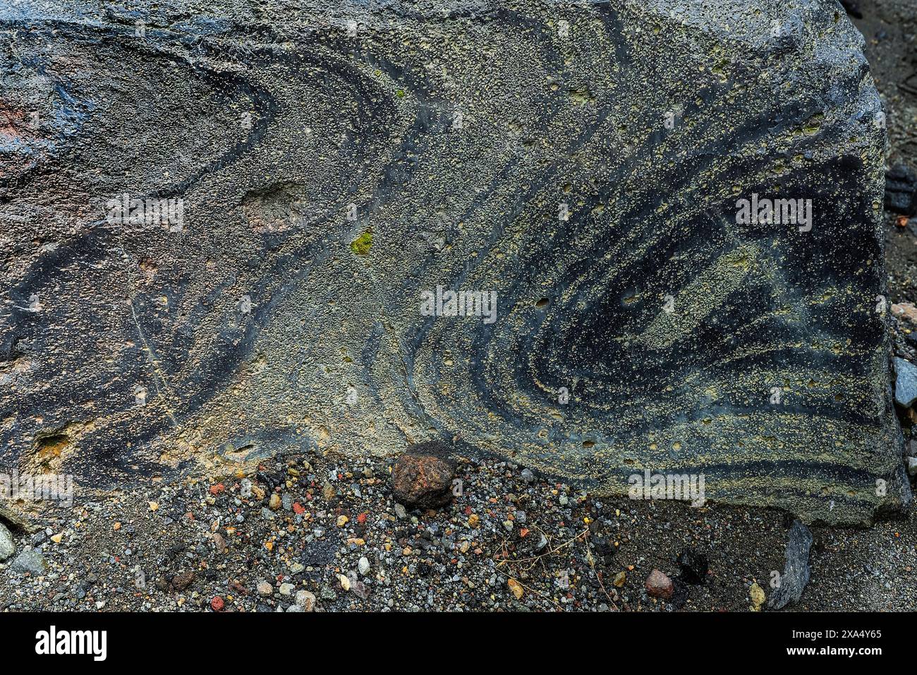 Swirly flow lines of volcanic glass obsidian within a piece of lava at ...