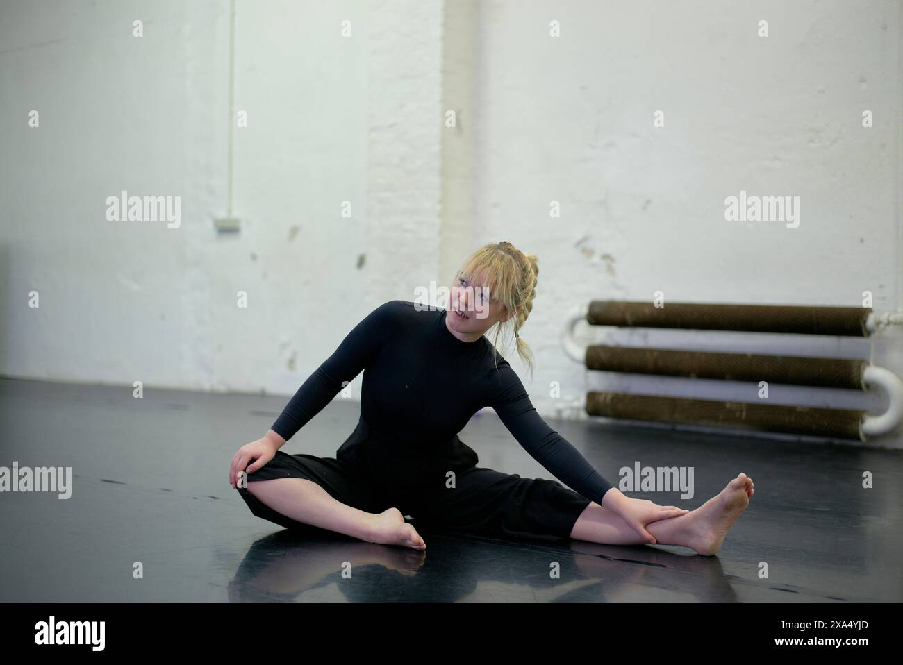 Dancer black attire sits floor dance studio hi-res stock photography ...