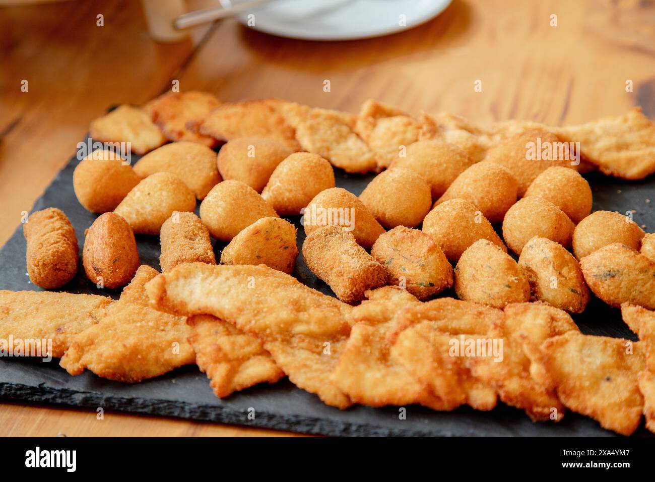 An inviting platter of assorted fried snacks, including golden-brown ...